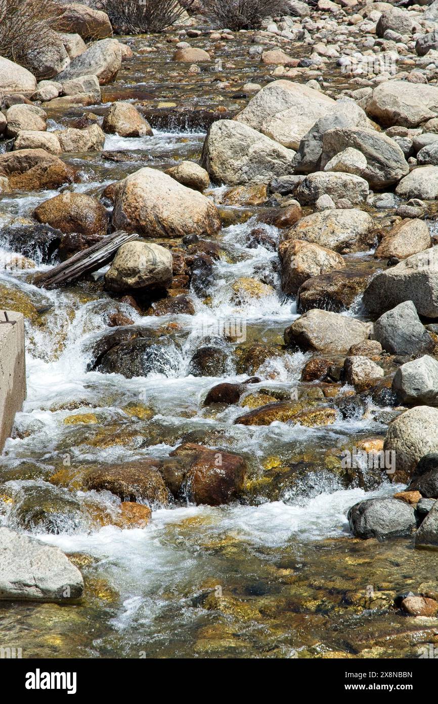 Roaring river flowing down over stones of alluvial fan in Rocky ...