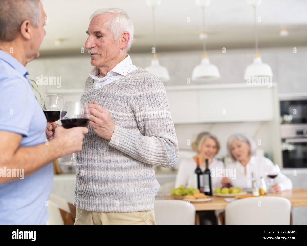 Two elderly men talking table hi-res stock photography and images - Alamy