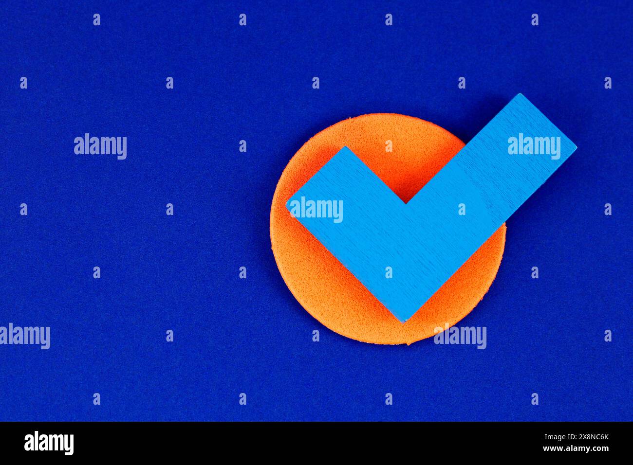 Check sign on orange circle Stock Photo - Alamy