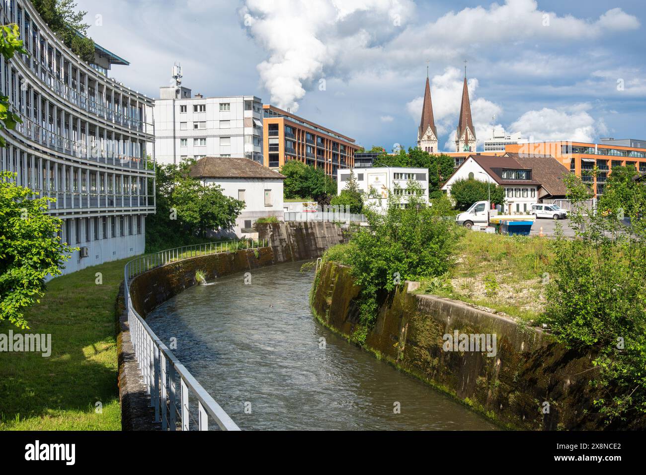 Urban scene in Olten with glass building by river Dunnern, traditional ...