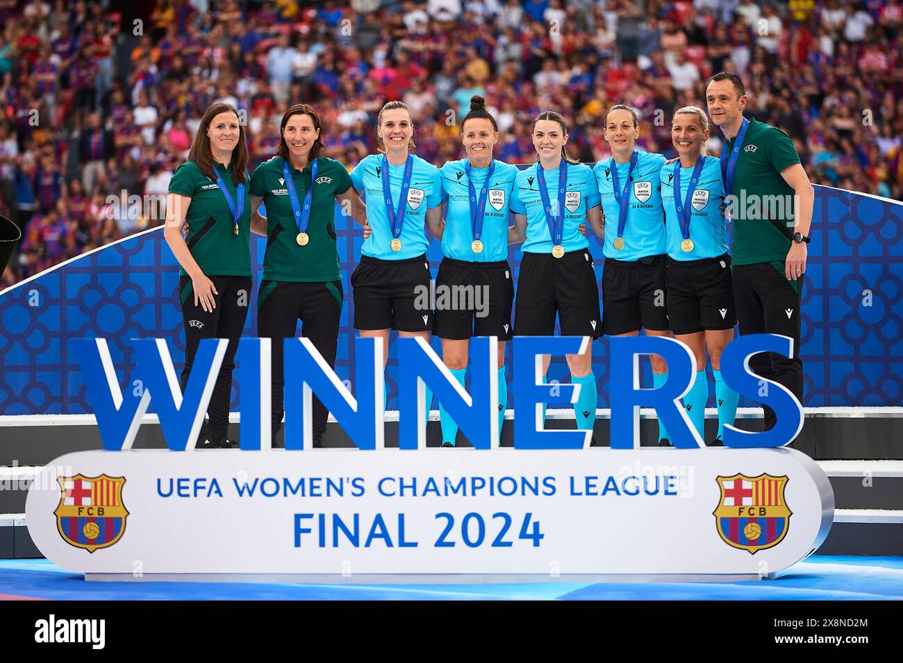 The match officials pose for a photo with their medals after the UEFA ...