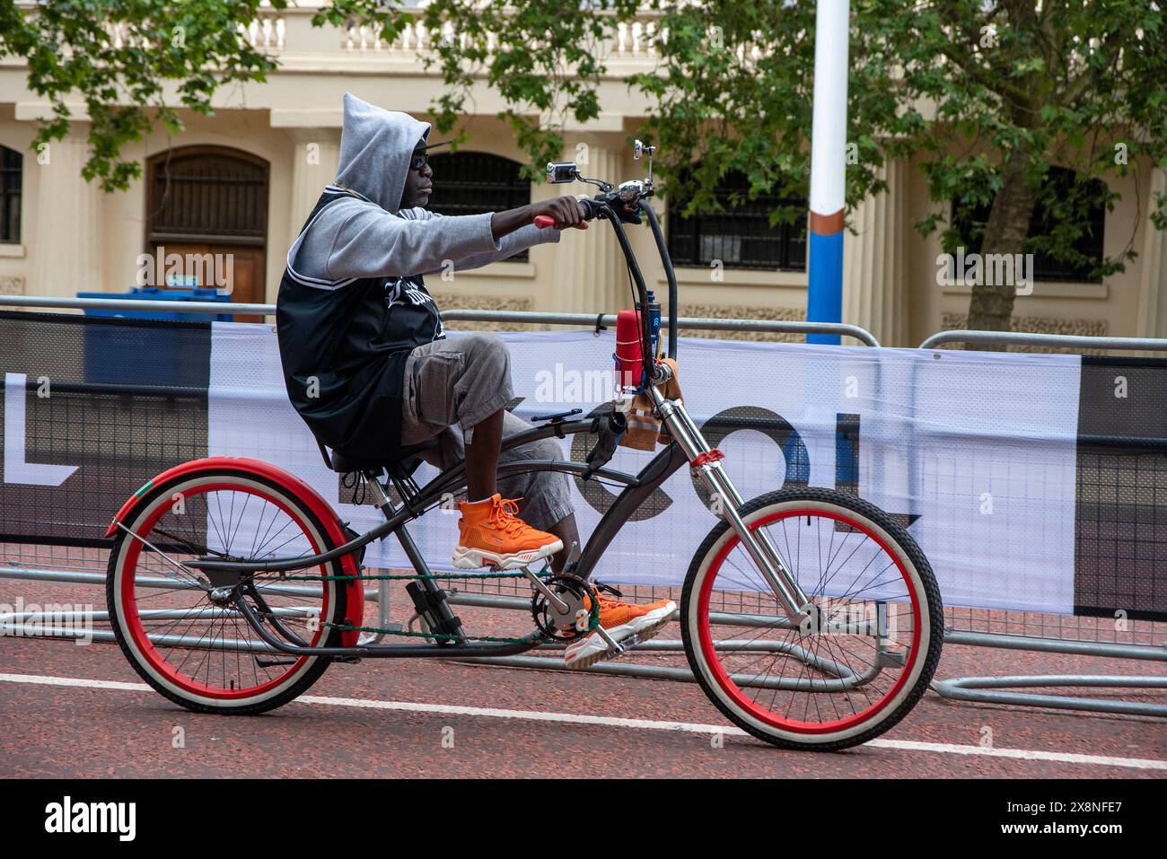 A rapper style cyclist enjoys the ride on The Mall in London. Thousands ...