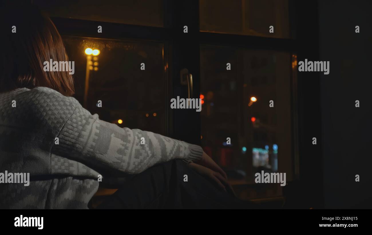 Rear view woman sitting sadly hi-res stock photography and images - Alamy