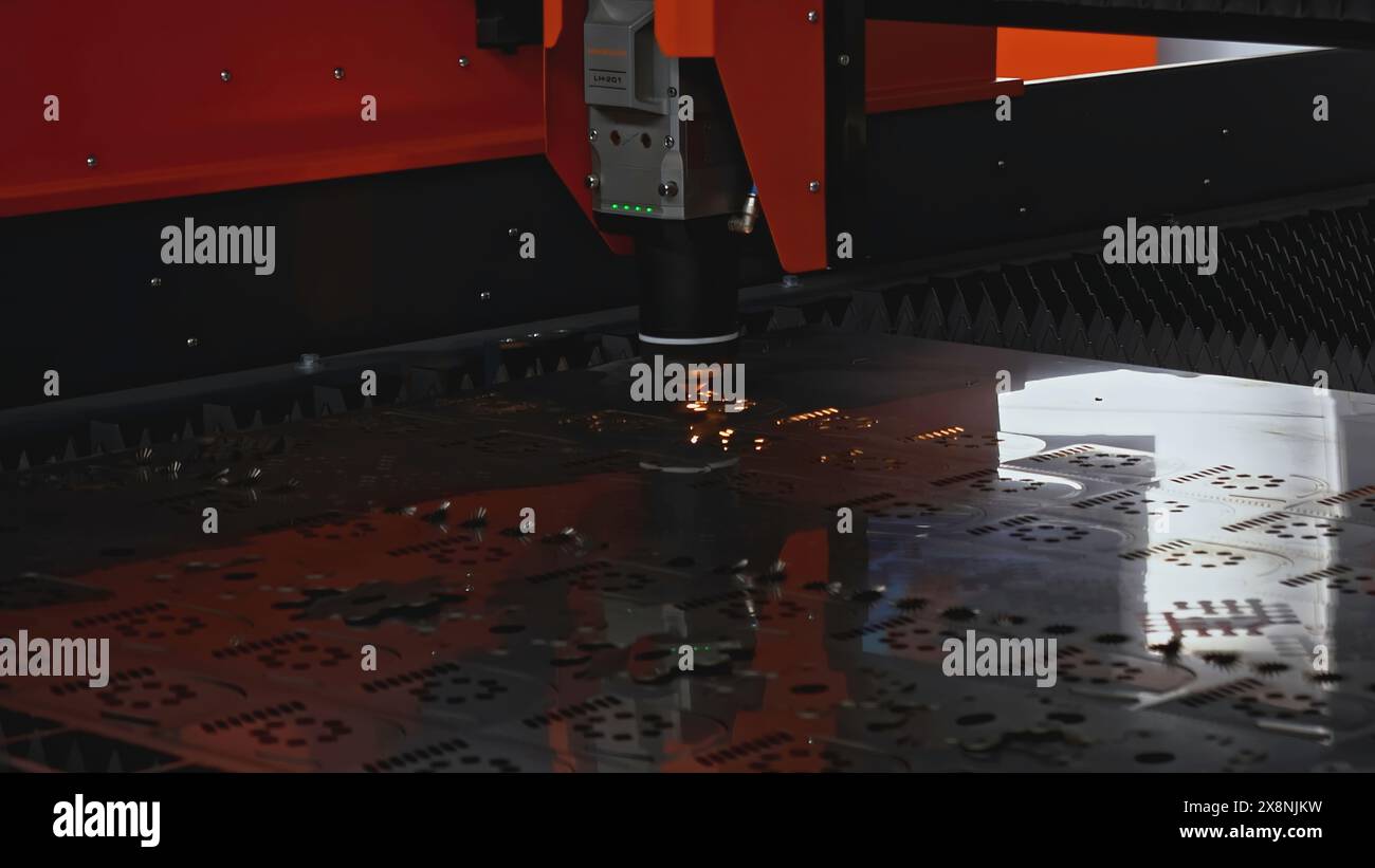 Industrial robotic machine cuts holes in metal. Media. Industrial ...