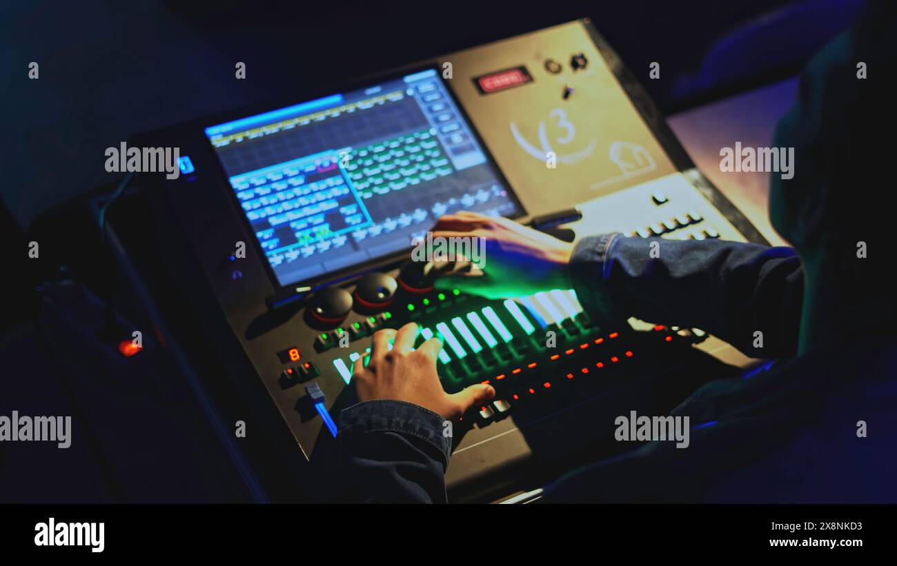 Light console control. Media. Man moves joysticks on light and sound ...