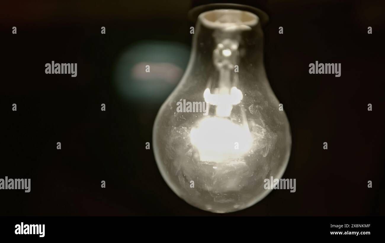 Switching on, turning off light bulb on white wall background. Footage ...