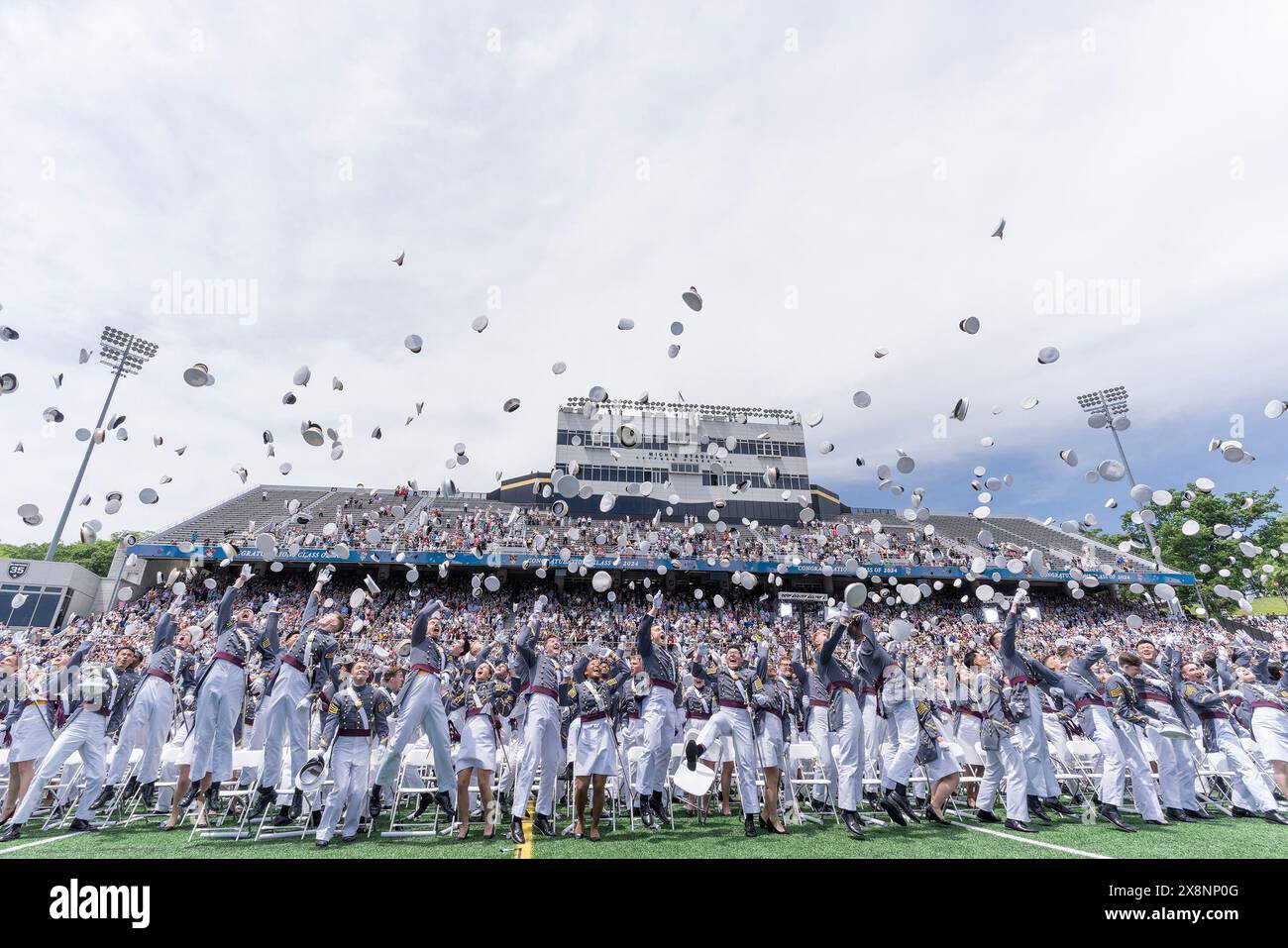 Graduates toss their hat as tradition after receiving diplomas during U ...