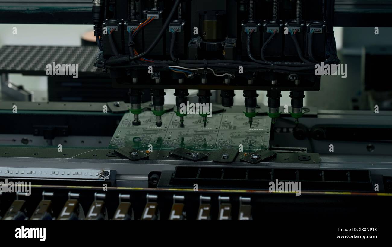 Automatic pick and place machine is installing components on circuit ...