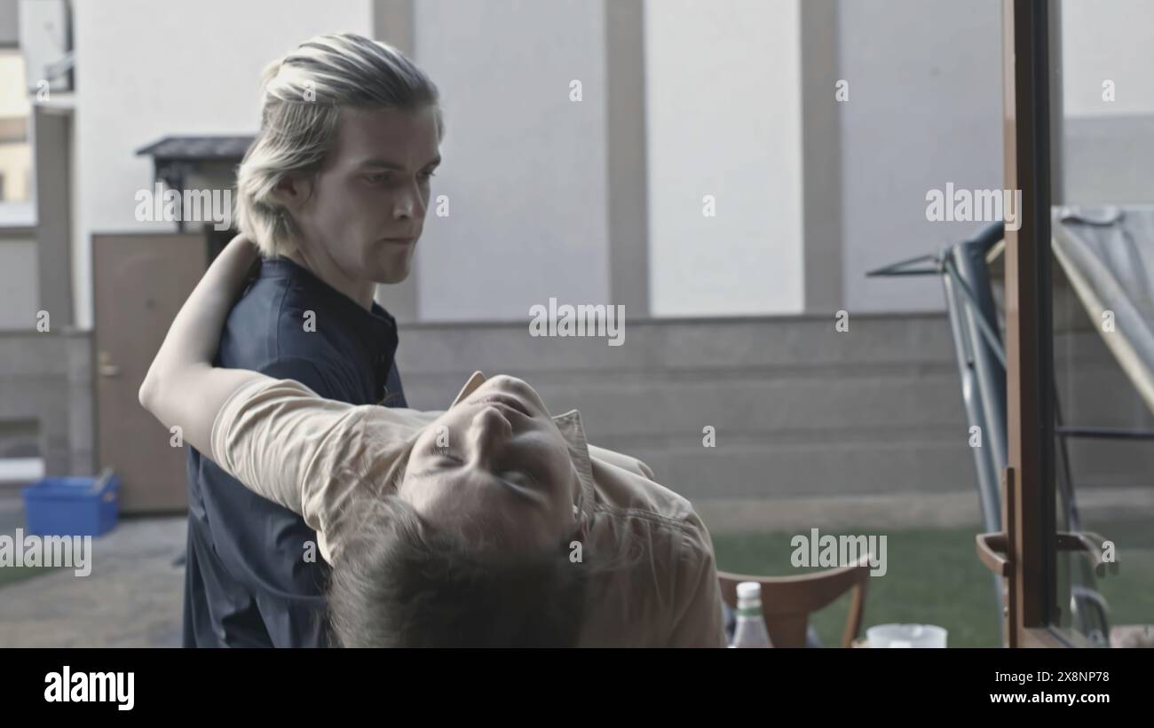 Young man carries unconscious woman. Stock. Young man brings ...