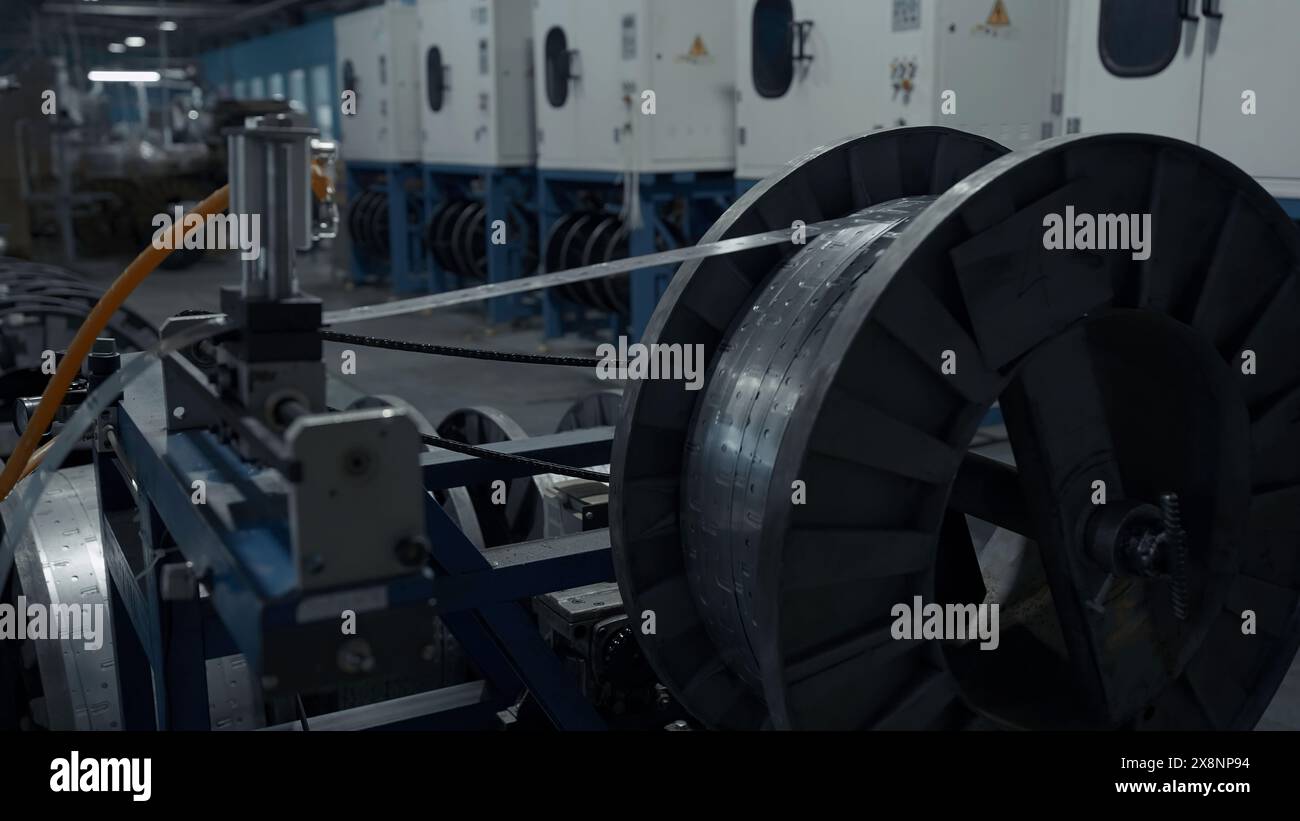 Metal long narrow sheets wraping on a bobbin. Creative. Large spool in ...