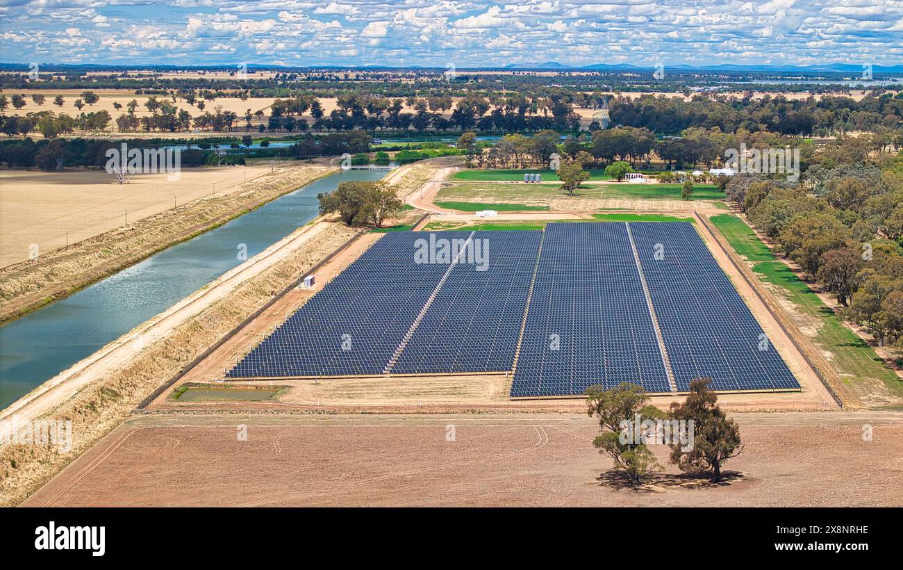 Aerial view of a solar panel farm beside a irrigation canal in New ...