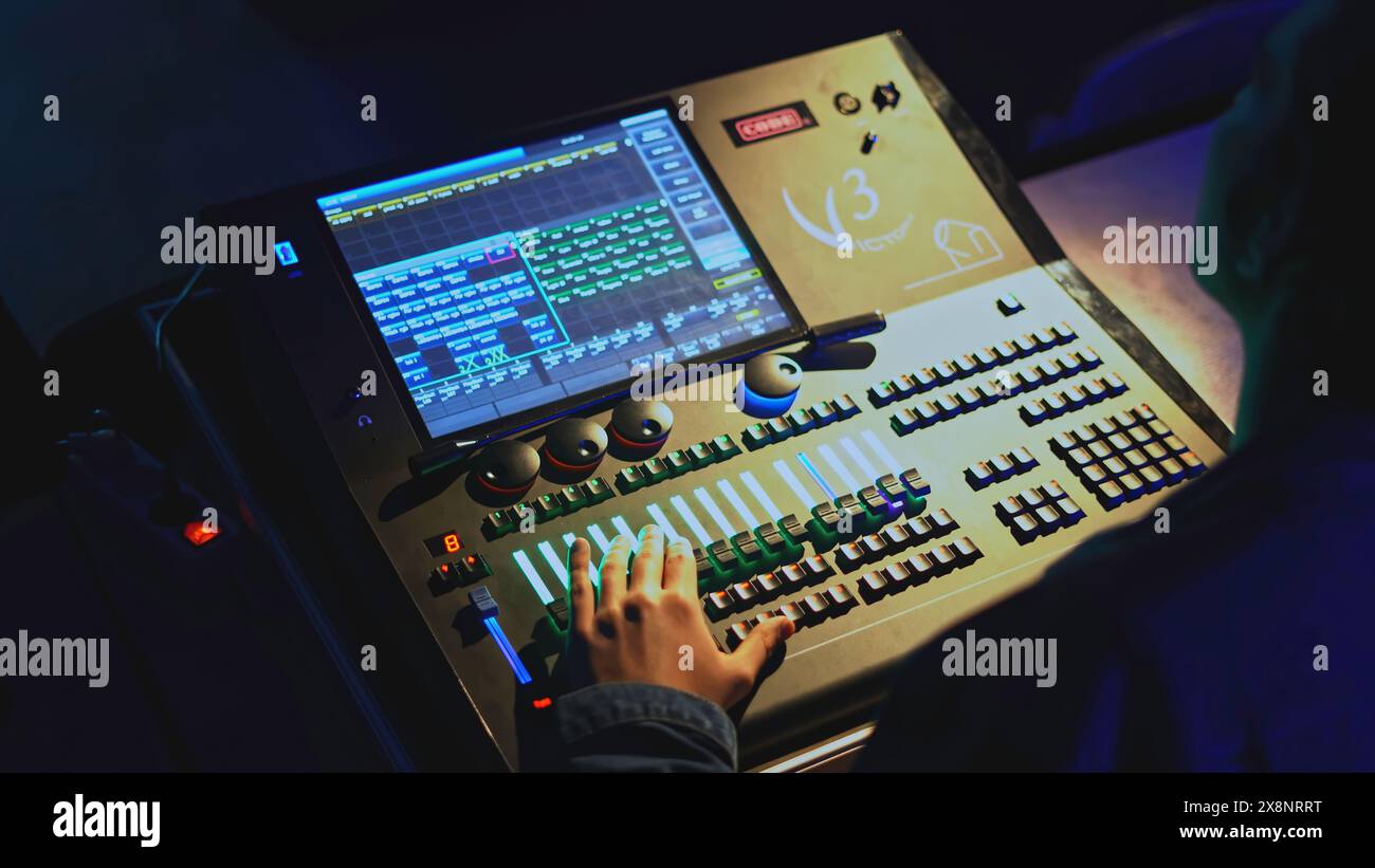 Light console control. Media. Man moves joysticks on light and sound ...