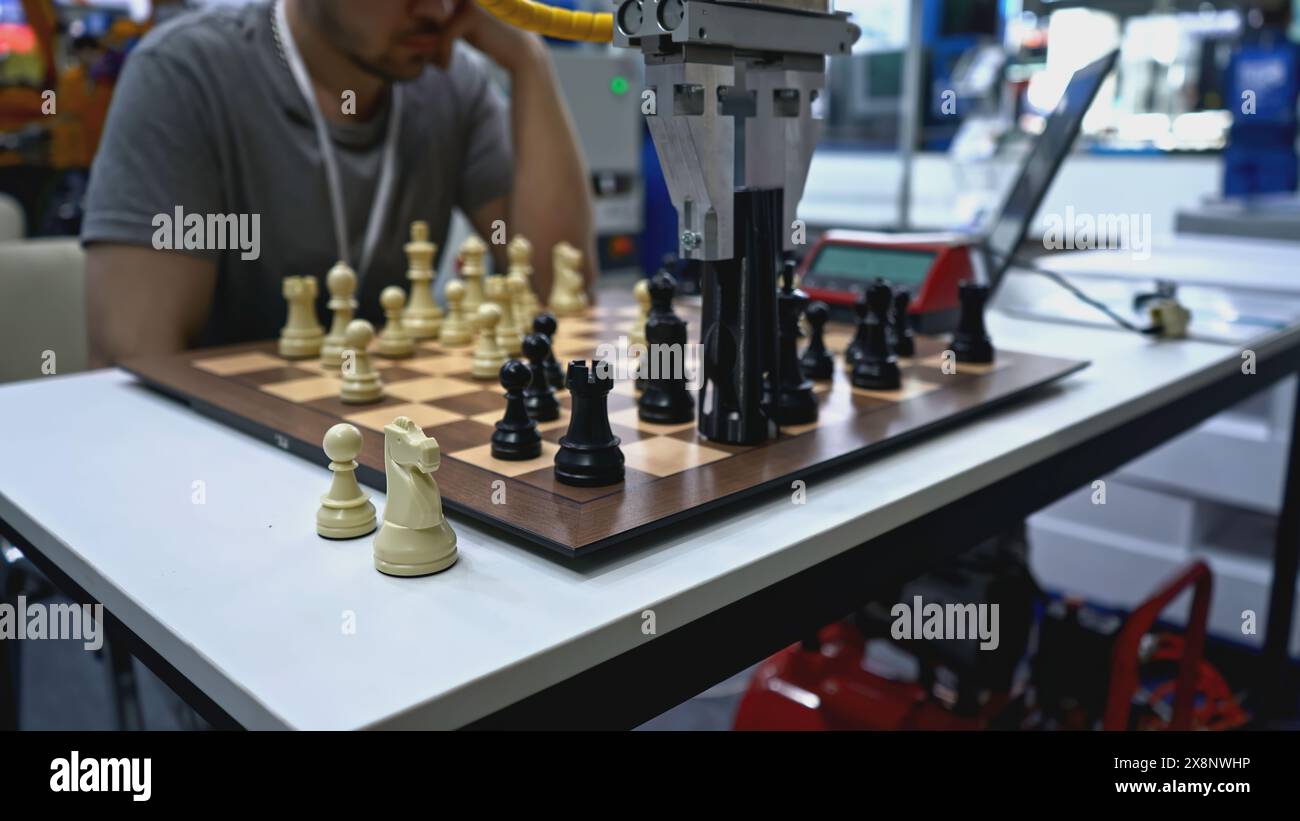 Man is playing chess with robot. Media. Man is playing chess against ...