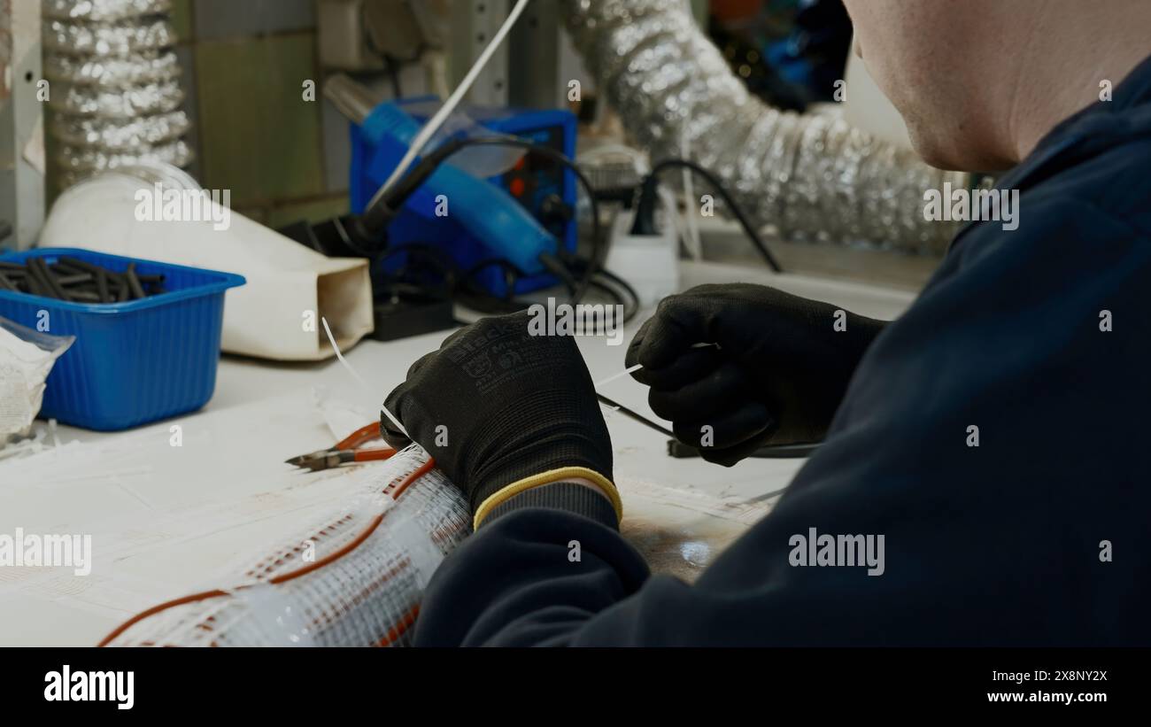 Master electrician working with electricity wires. Creative. Workshop ...