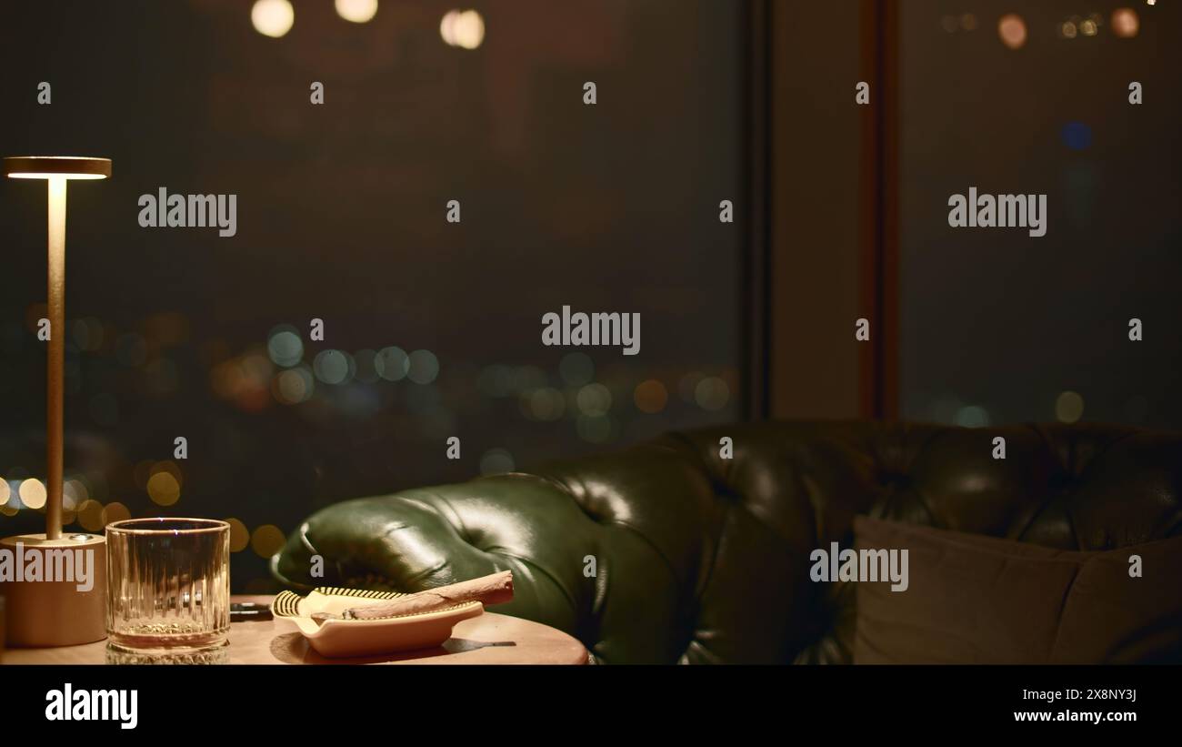 Smoking cigar on table in restaurant. Media. Close-up of smoking cigar ...