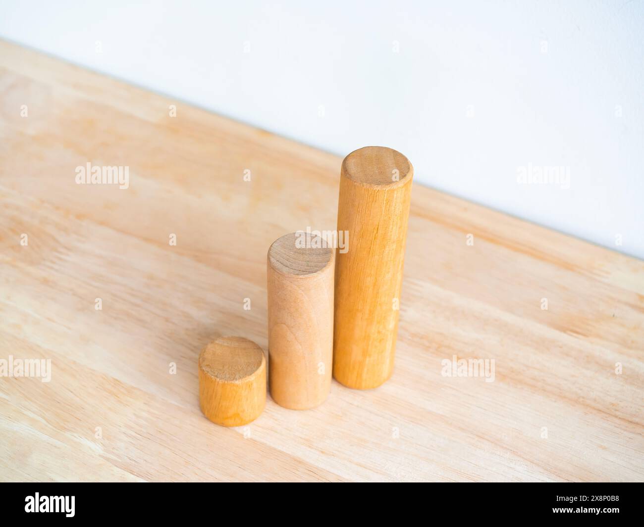 Three size of simple cylindrical wooden sticks as a business chart ...