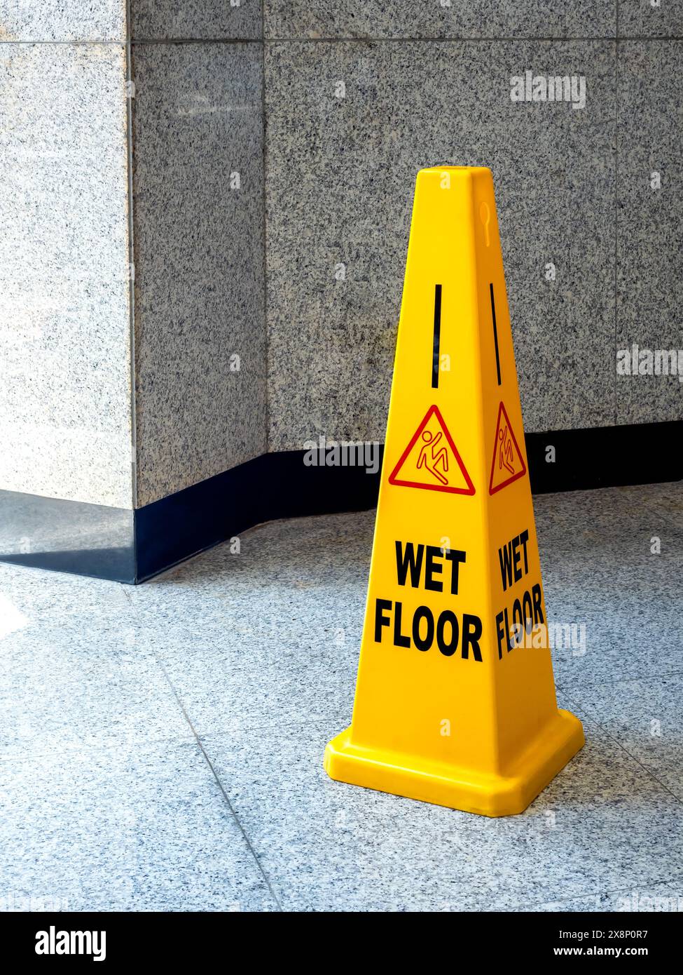 Wet floor caution sign on walkway in modern building. Warning red slip ...