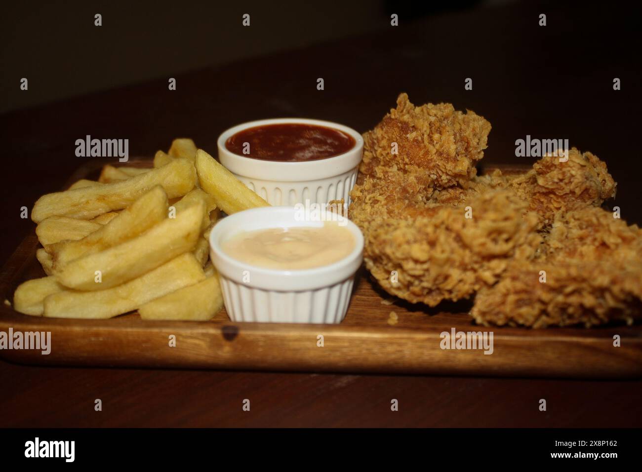 Chicken broast with fries and ketchup Stock Photo - Alamy