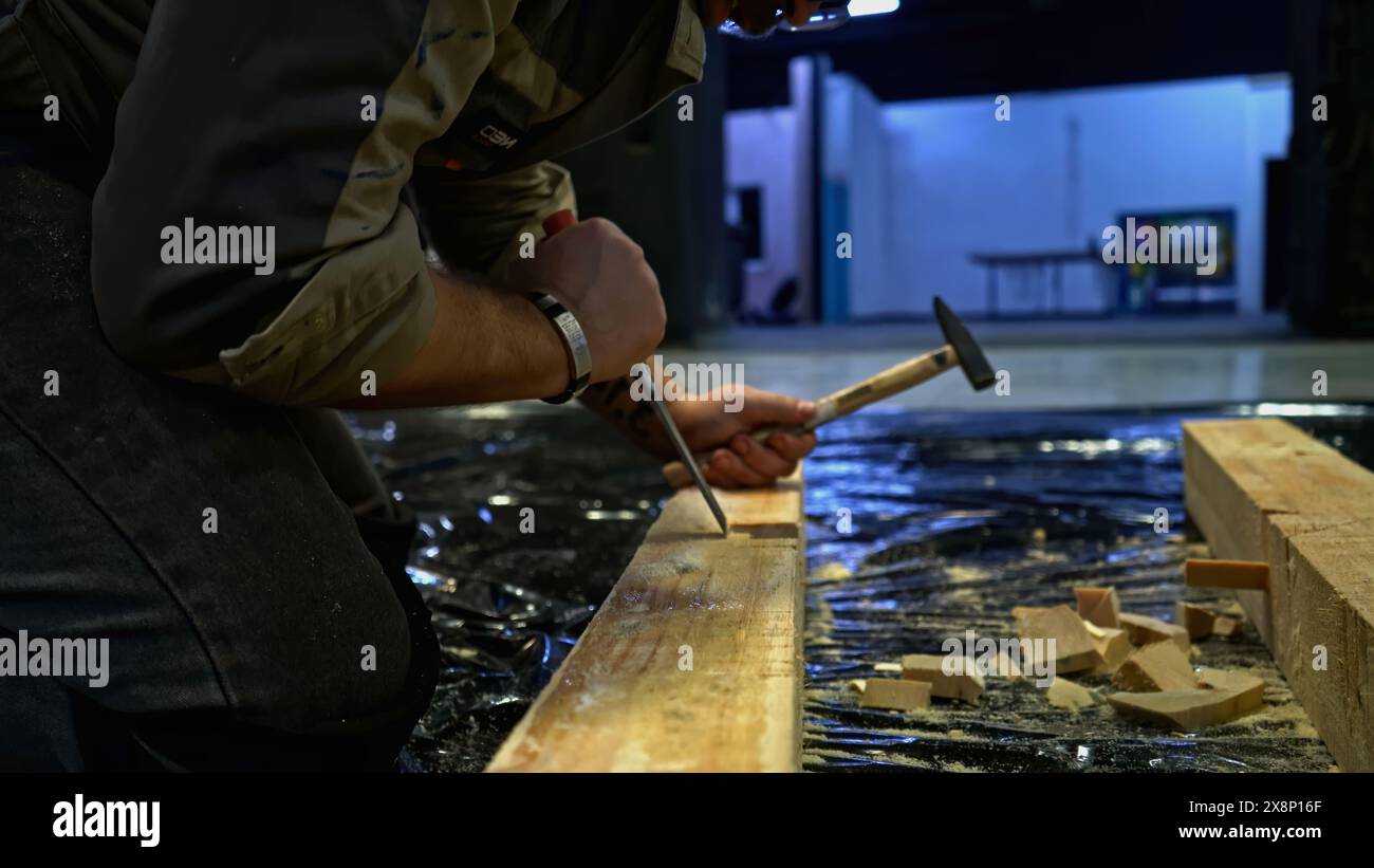 Close up of worker using tools for making holes in wooden beam. Media ...