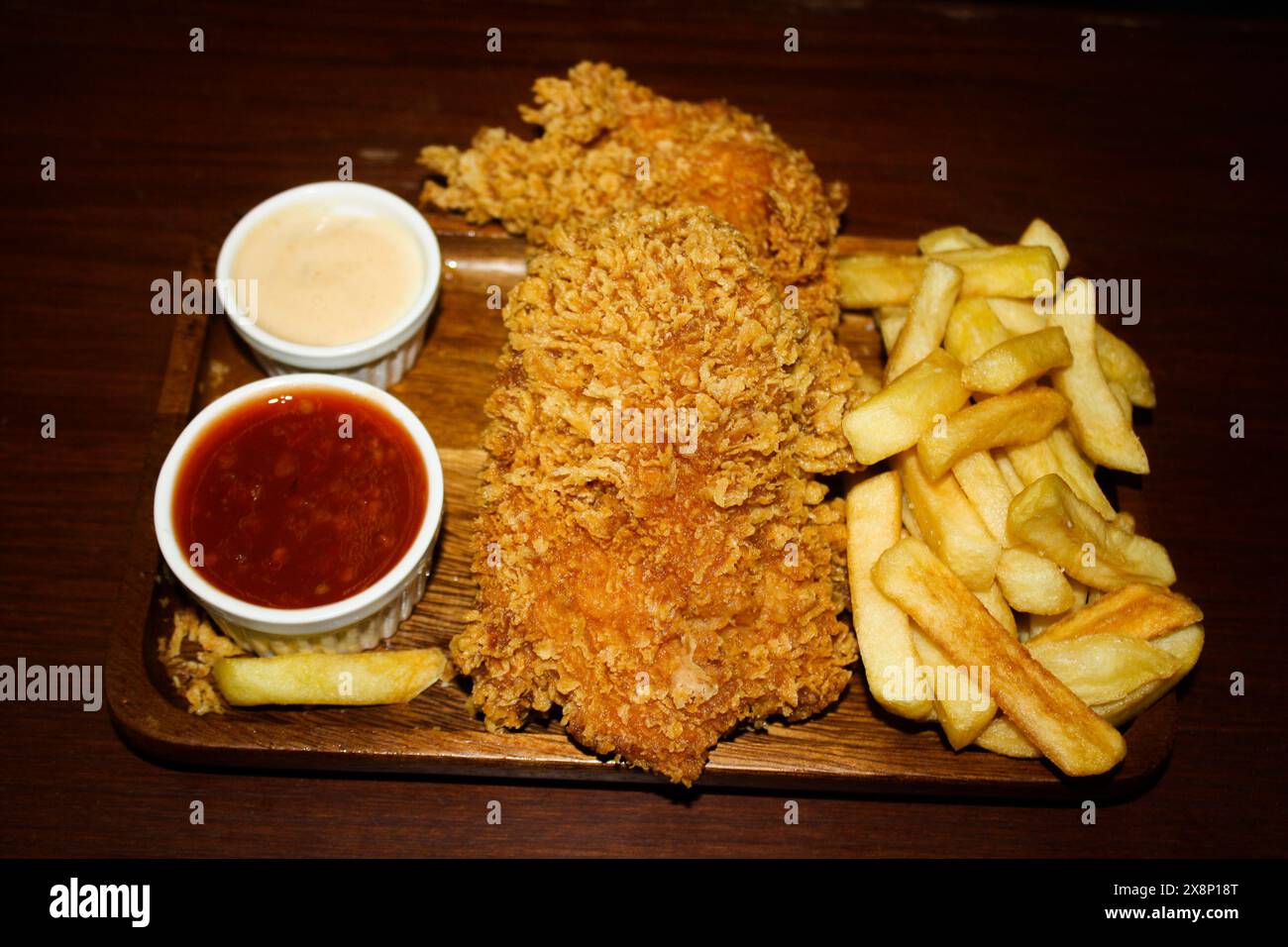 Chicken broast with fries and ketchup Stock Photo - Alamy
