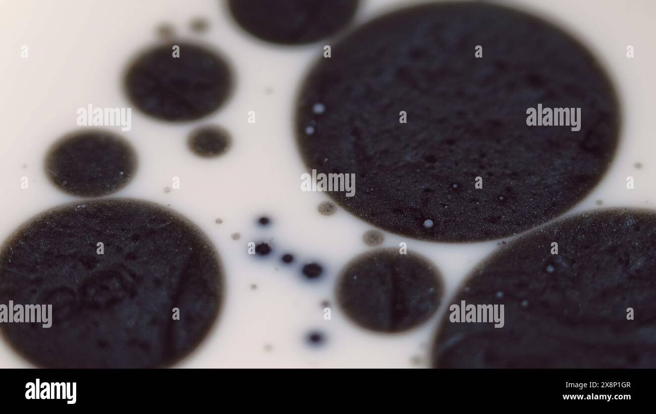Glitter blobs. Ink oil. Defocused black white color dark spots ...