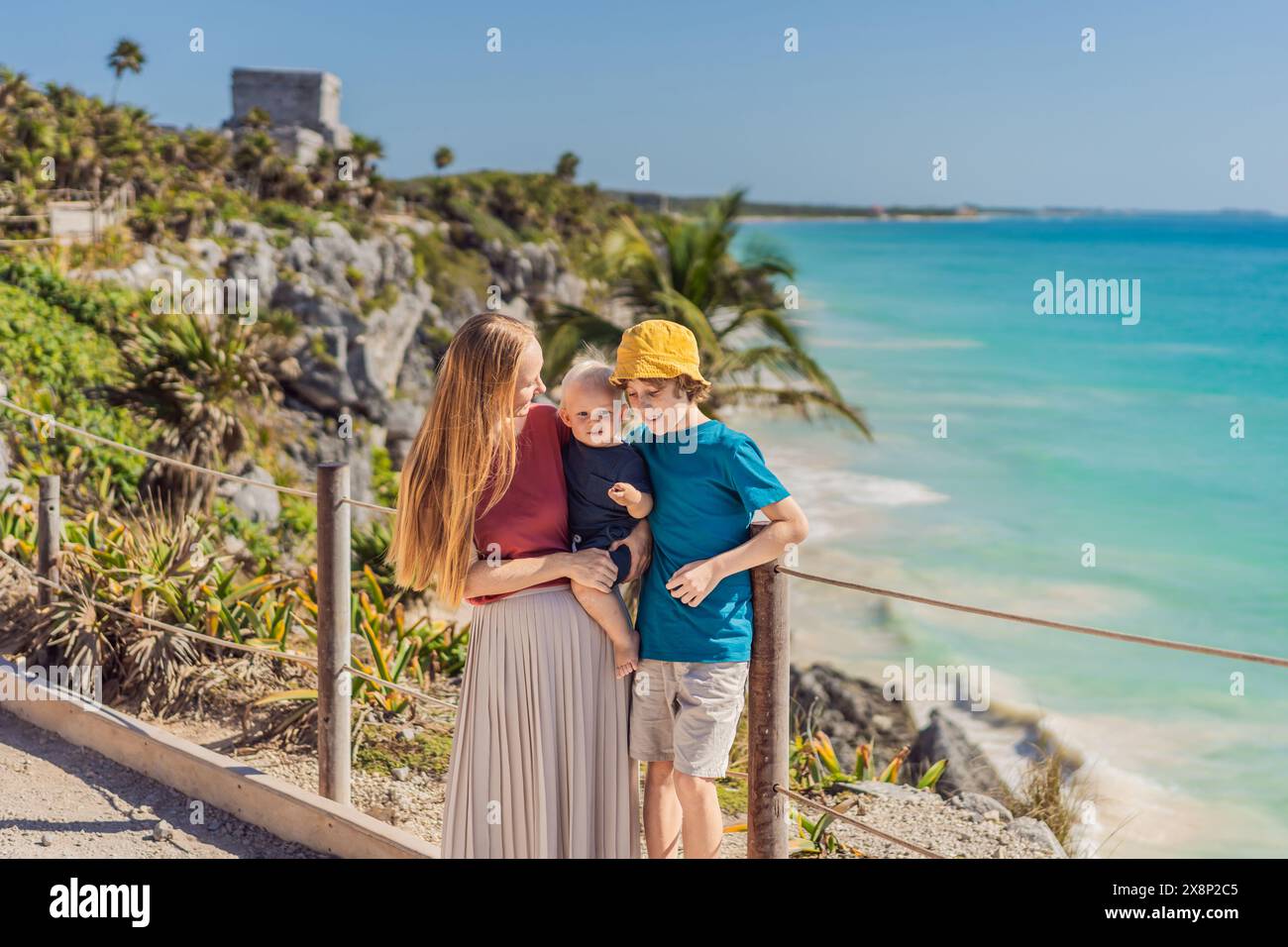Mother and two sons tourists enjoying the view Pre-Columbian Mayan ...