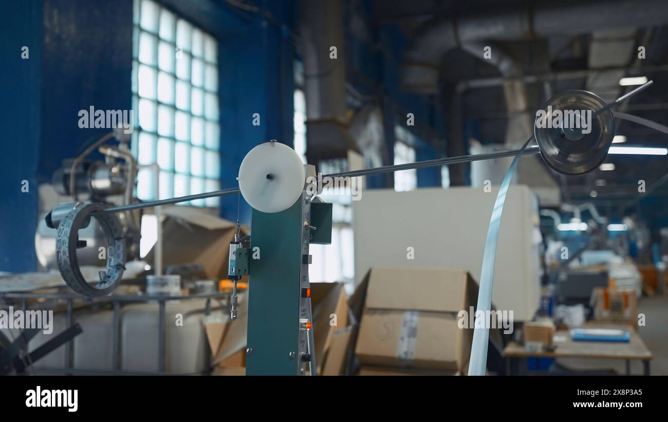 Metal strip rotates on industrial machine. Creative. Industrial machine ...