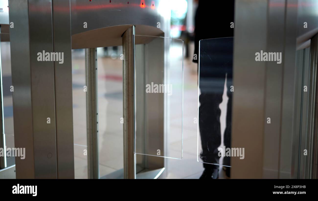 Businessman entering office building trough security gates. Media. Man ...