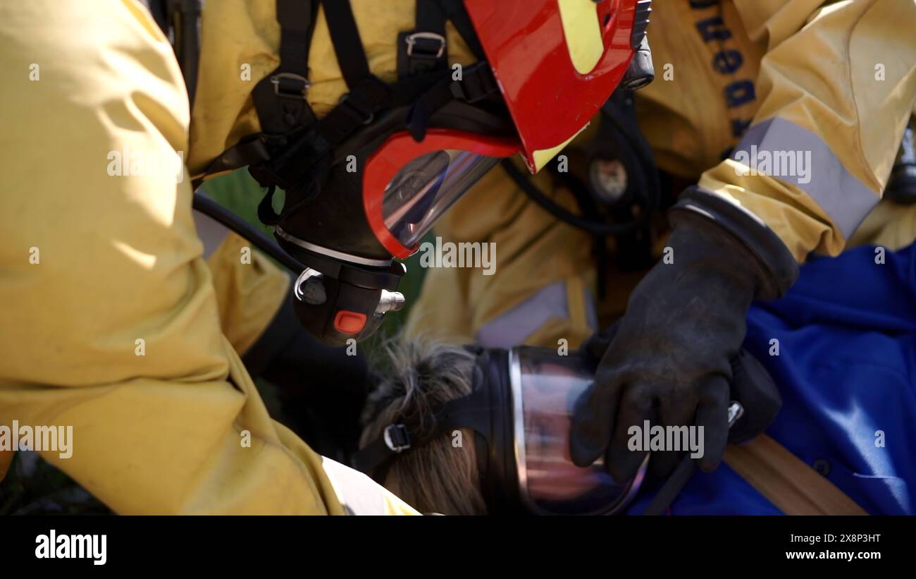 Firefighters giving oxygen to woman victim of fire. Clip. Close up of ...