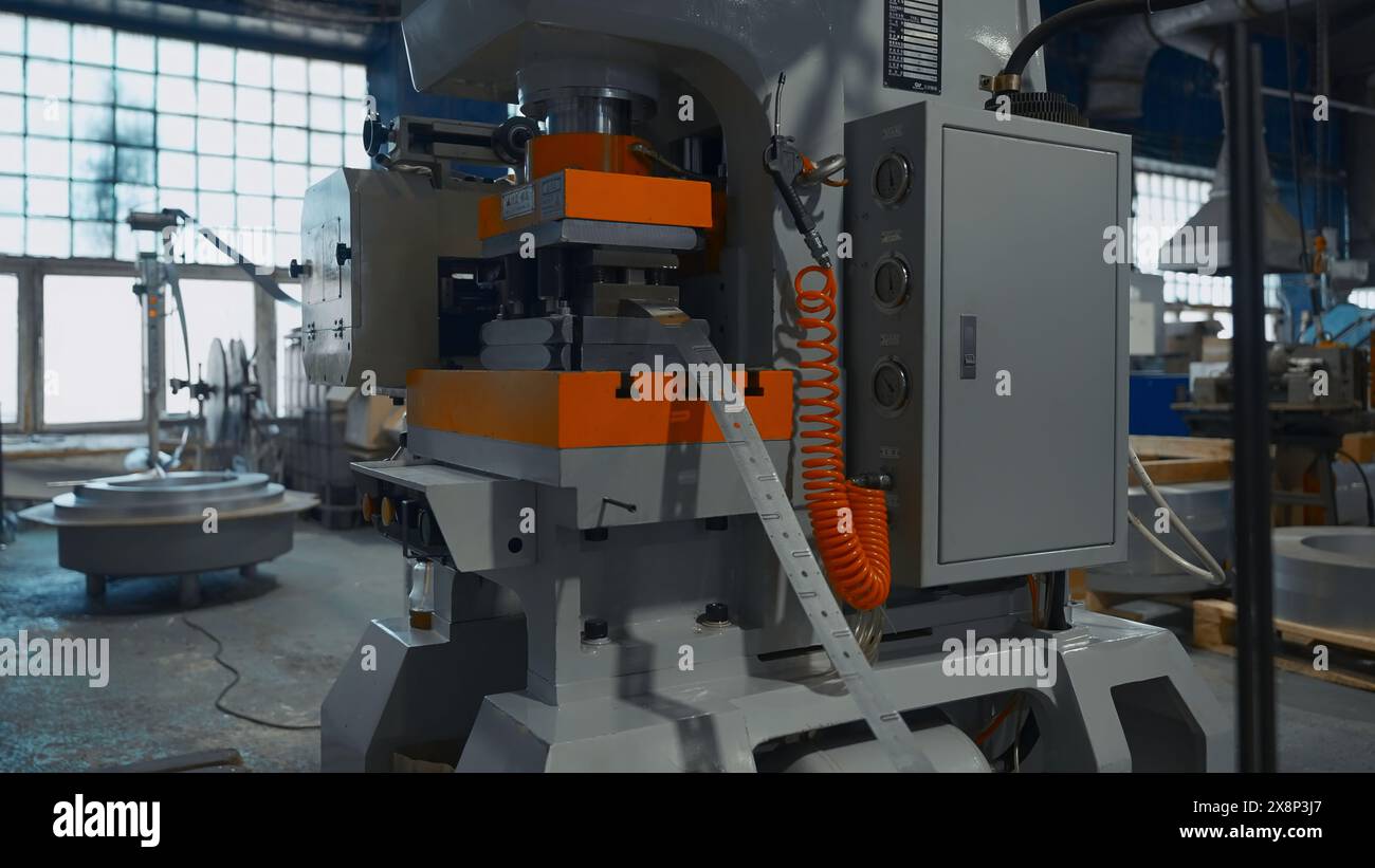 Machines with hole punch for metal line. Creative. Long metal line on ...