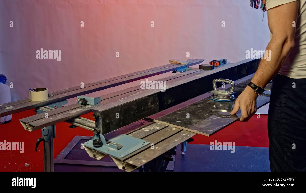 Manufacturing and processing of granite slabs. Creative. Worker using ...