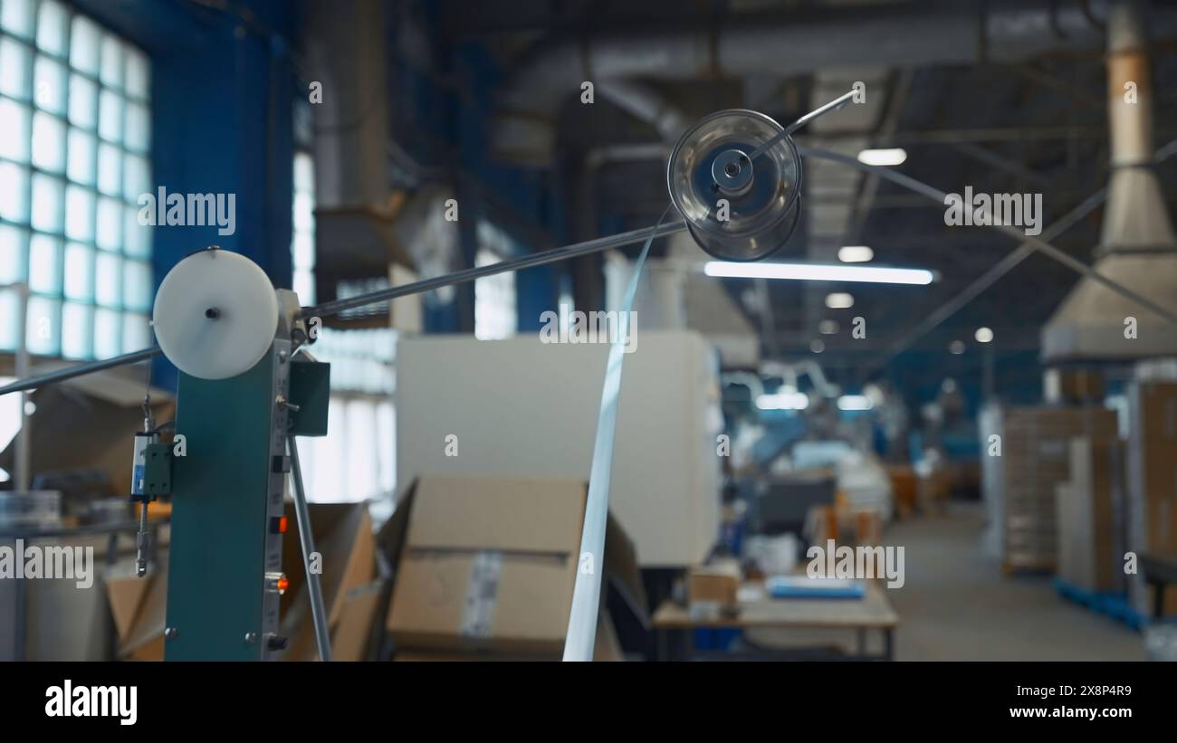 Metal strip rotates on industrial machine. Creative. Industrial machine ...