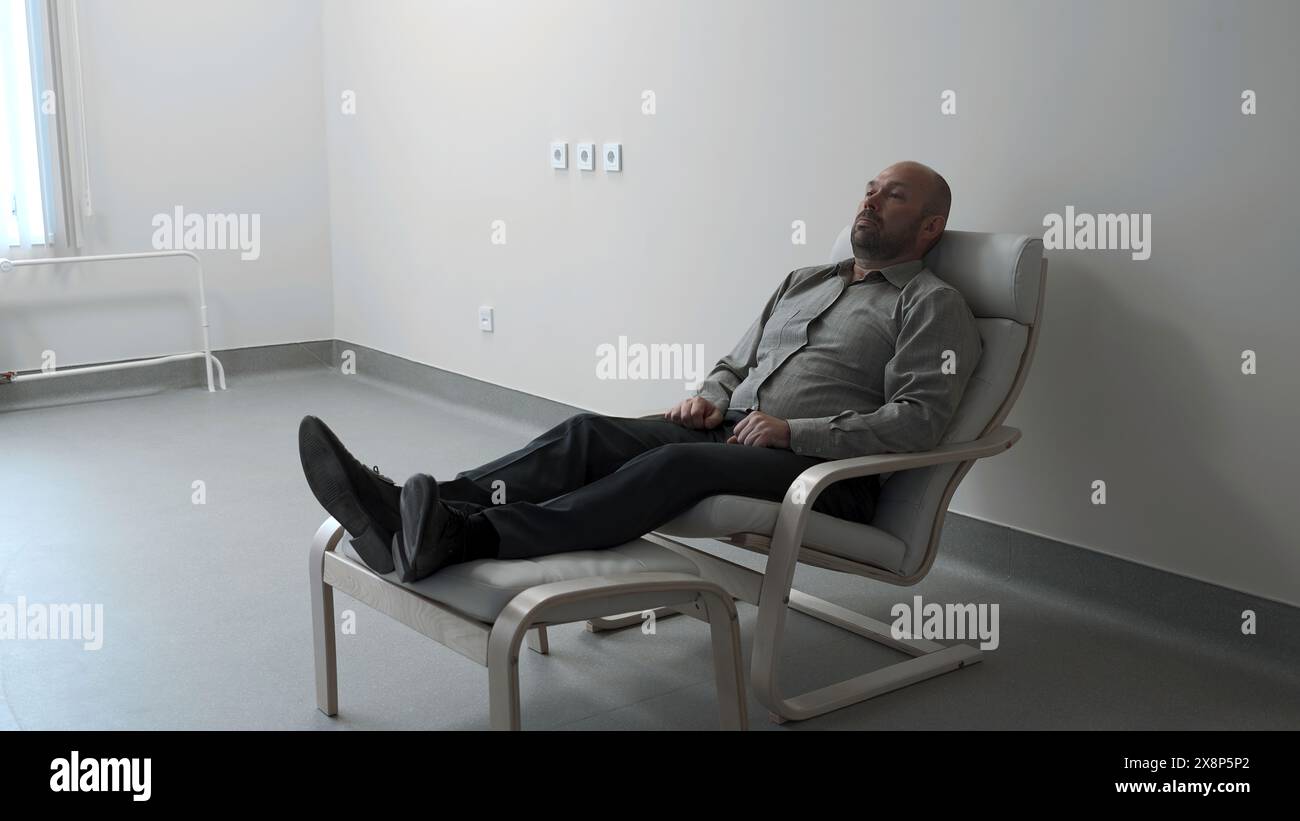 Man is lying in armchair in office. Clip. Man is lying in armchair in ...