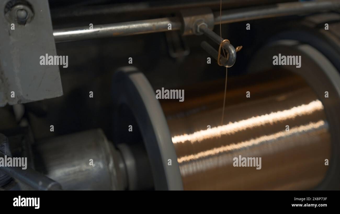 Close-up of coil winding copper wire. Creative. Shiny copper wire is ...