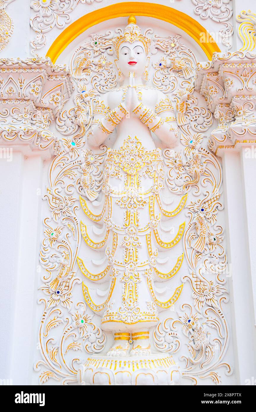 Bas relief of devada (angel) on scripture library at Wat Chang Kham ...