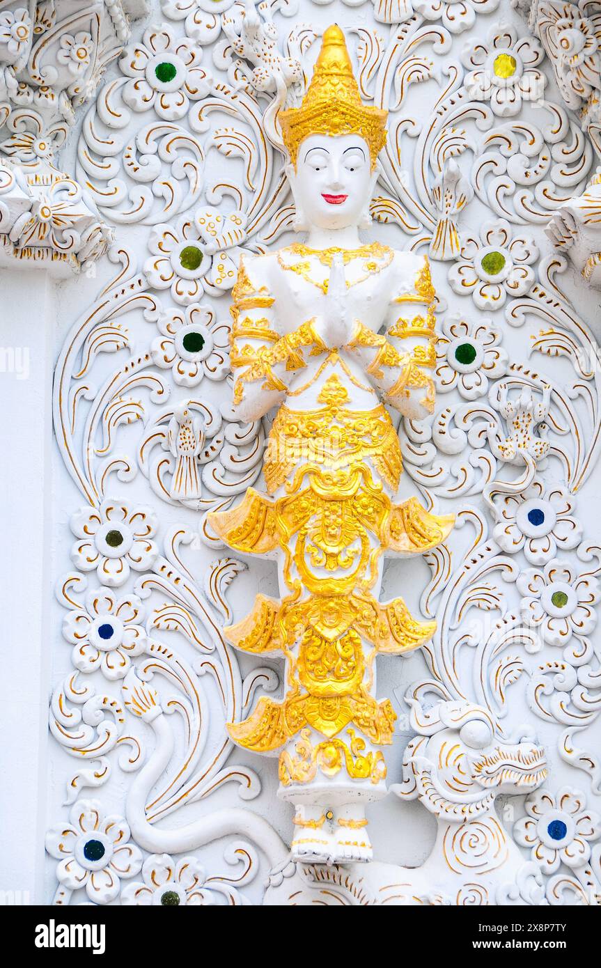 Bas relief of devada (angel) on scripture library at Wat Chang Kham ...