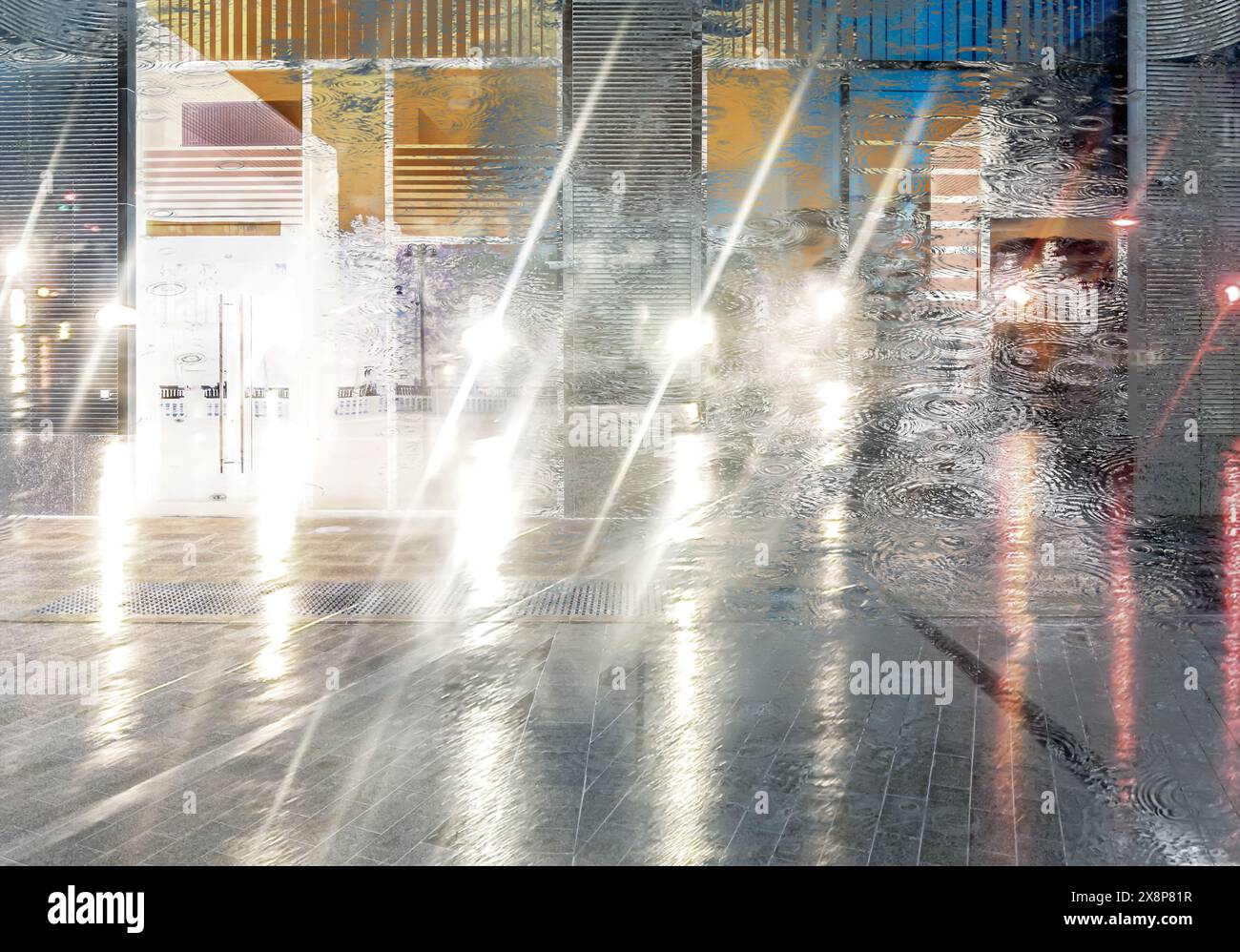 multi exposure. lights of cars driving at night with urban architecture ...