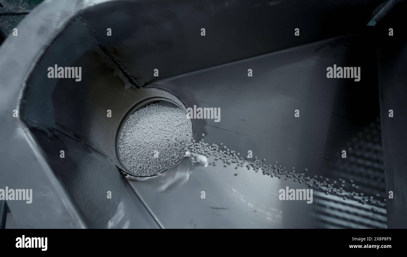 Pouring pile of plastic particles. Creative. Process of filling ...