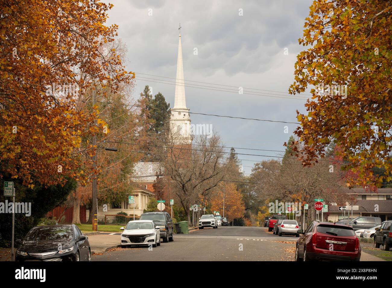 Aumtum cloudy light and foliage frame homes and a church building in ...