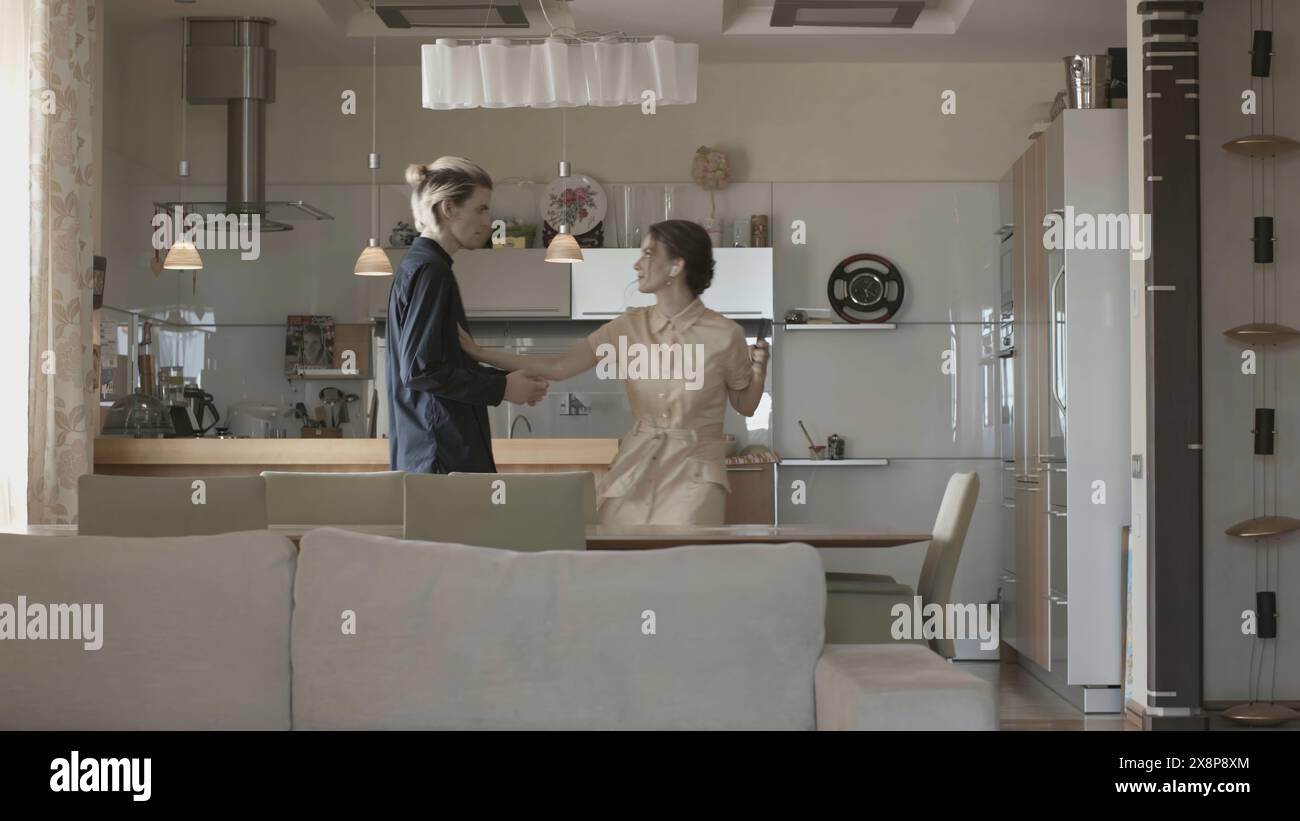 Young couple is fighting over phone. Stock. Young woman talks to man ...