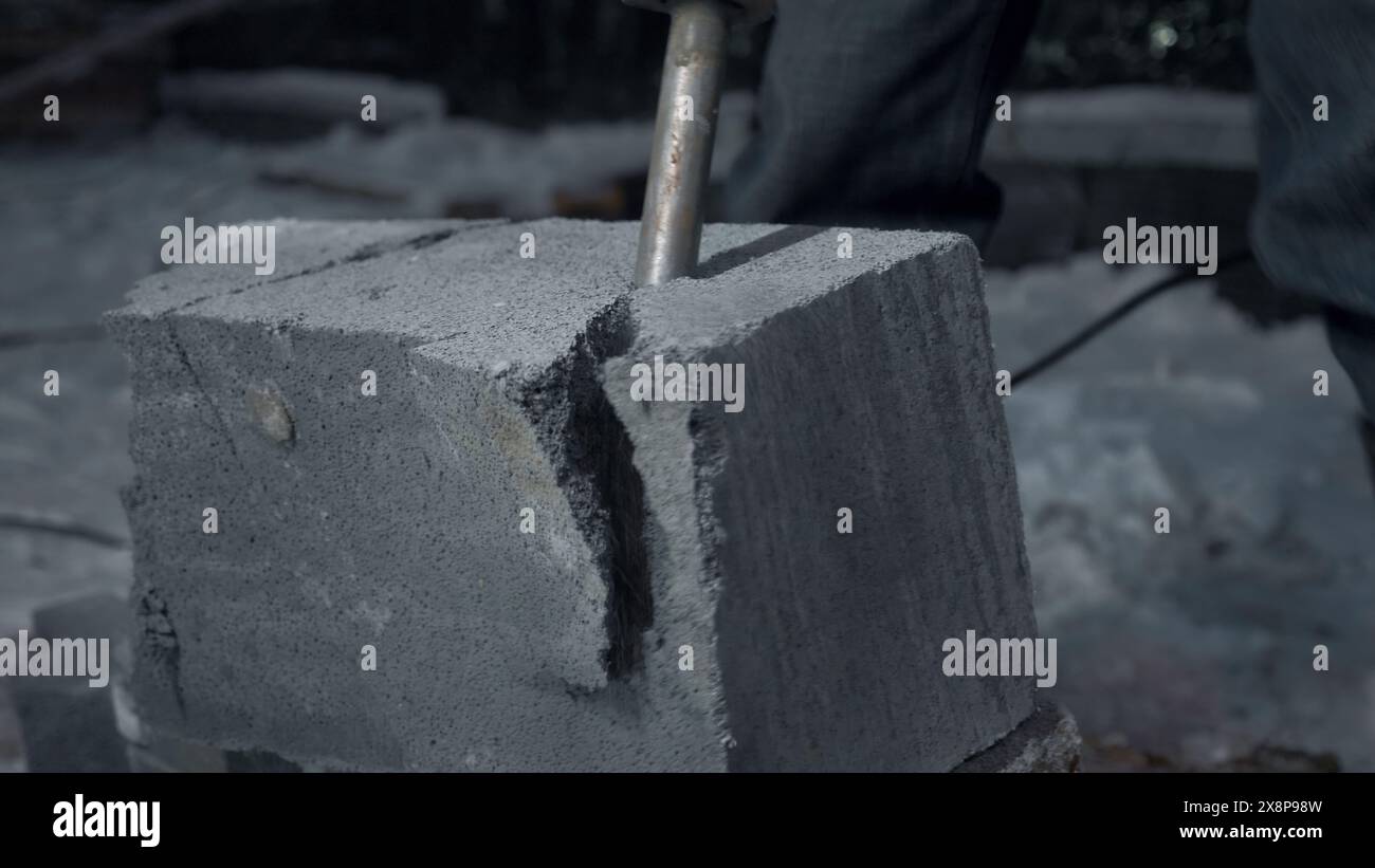 Man drills cement blocks. Clip. Worker splits cement blocks at ...