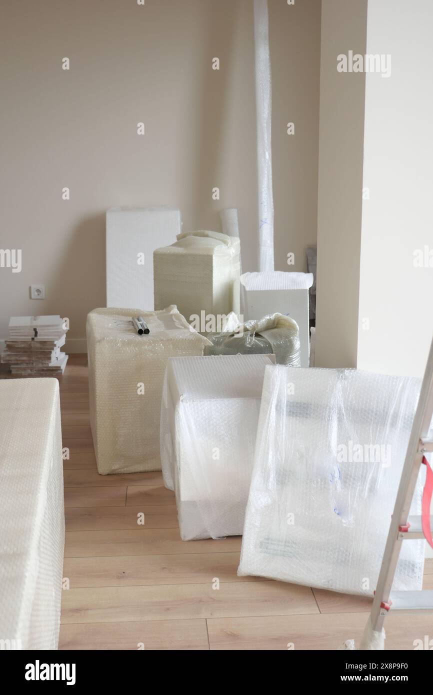 An empty room with hardwood flooring and wrapped in plastic Stock Photo ...