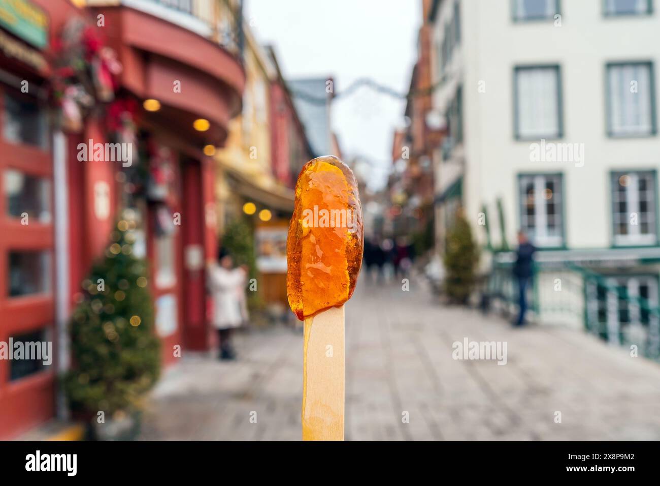 Maple syrup candy on stick in Quebec City, Canada Stock Photo - Alamy