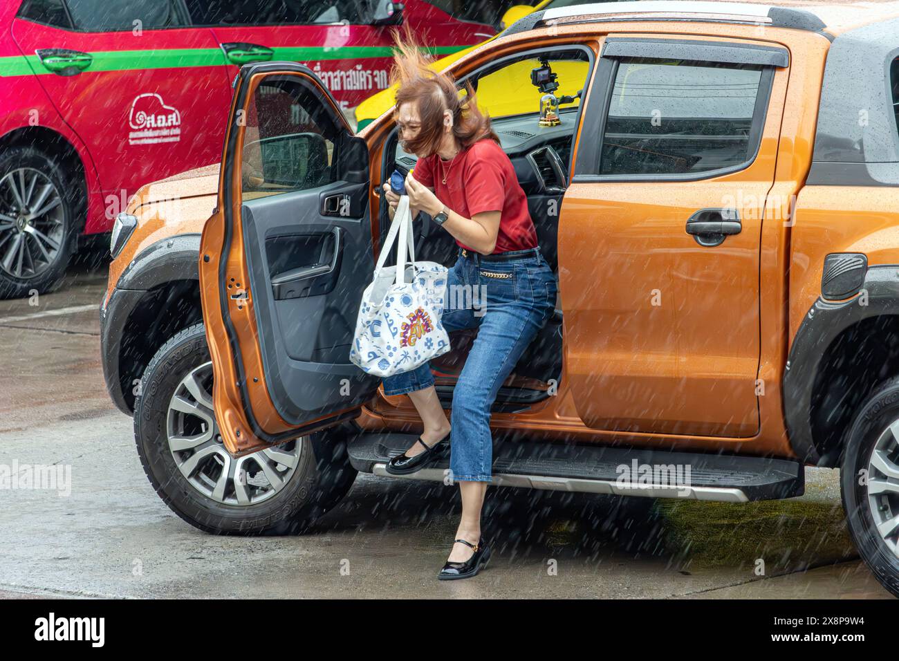SAMUT PRAKAN, THAILAND, MAY 07 2024, A woman with flowing hair gets out ...