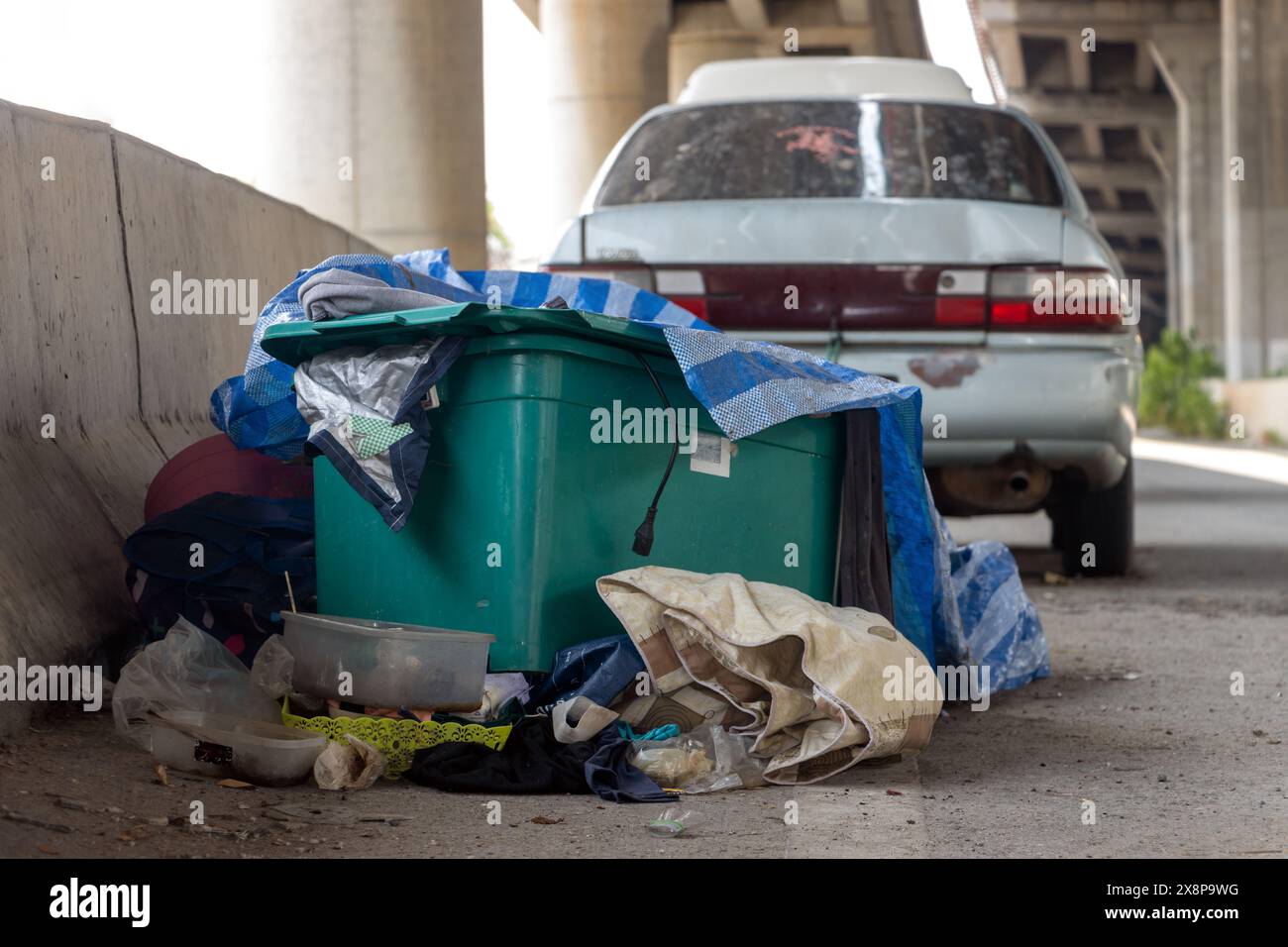 A mess between cars parked under the viaduct Stock Photo - Alamy
