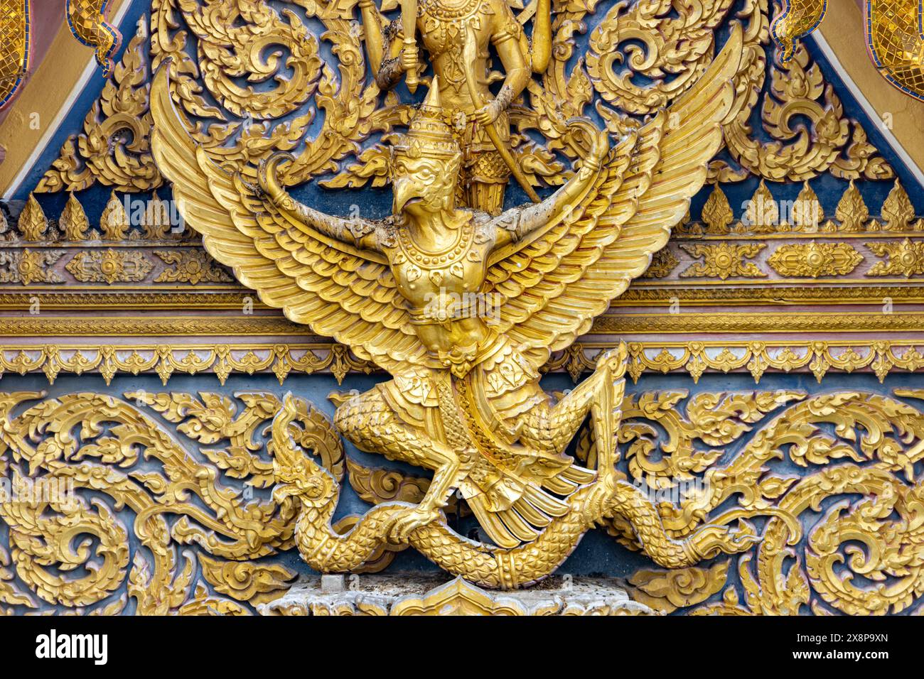 The facade over entrance of the Buddhist temple with the figure of ...