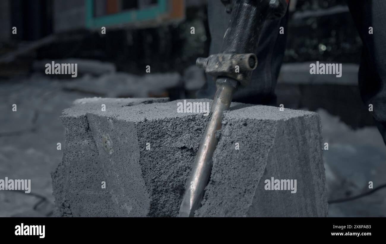 Man drills cement blocks. Clip. Worker splits cement blocks at ...
