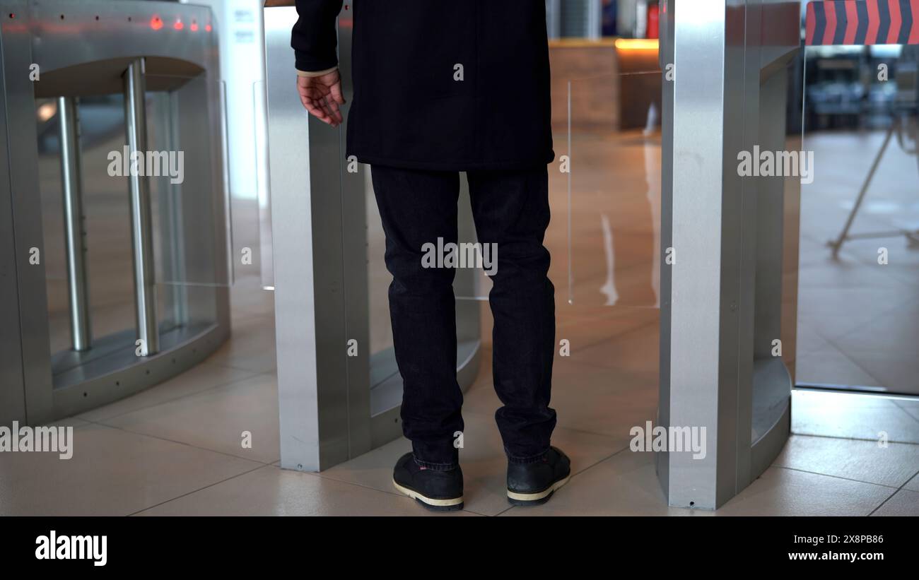 Businessman entering office building trough security gates. Media. Man ...