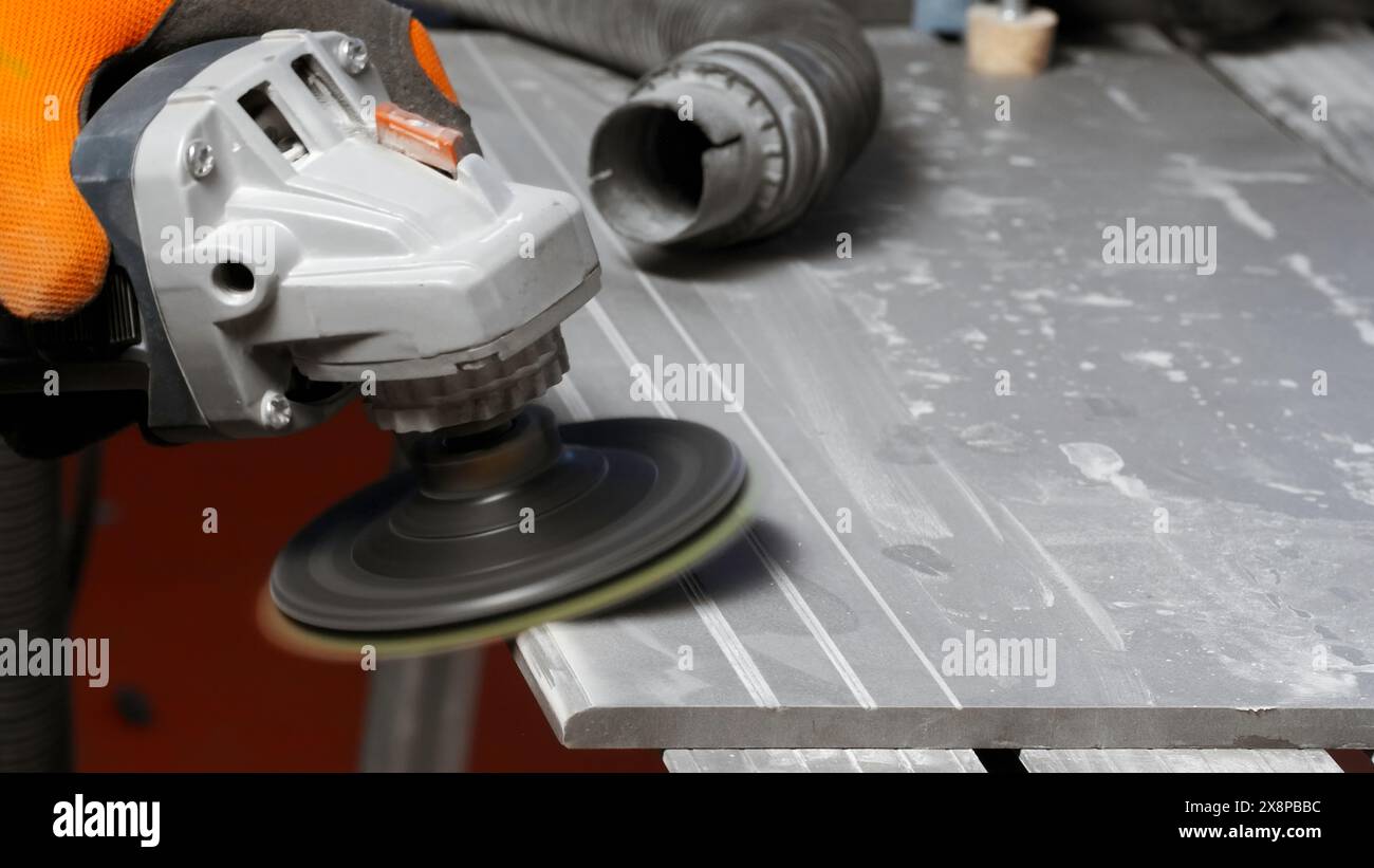 Process of grinding raw wood plank with angle grinder in workshop ...