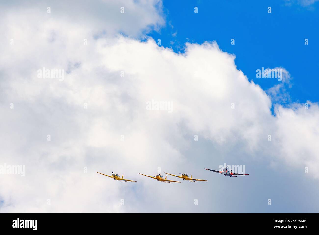 Airplanes flying in formation among the clouds in the sky Stock Photo ...
